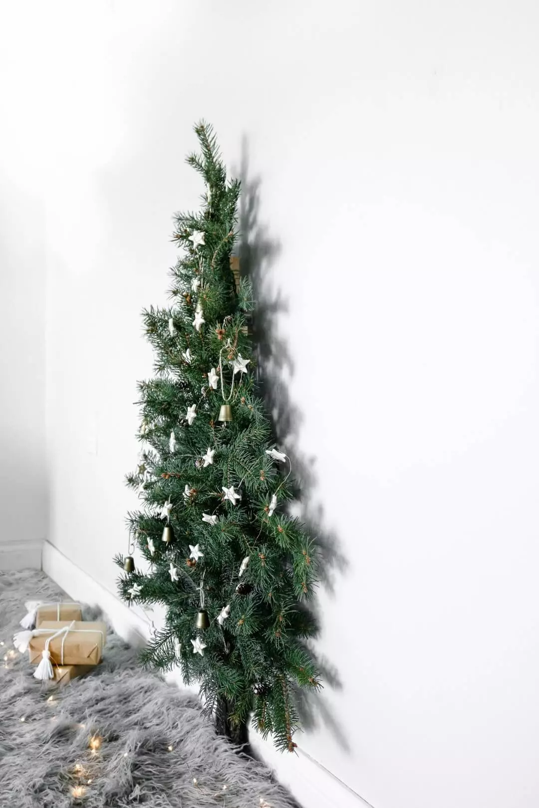 Wall Christmas tree with her hands from fir branches
